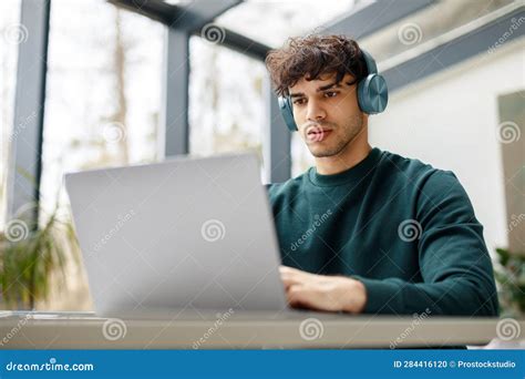 E Learning Concept Focused European Guy In Headphones Looking At