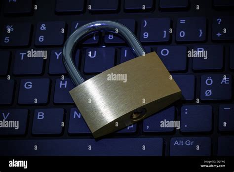 Close Up Of A Locked Padlock On A Computer Keyboard With Blue Hue Concept Photo Of Technology
