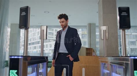 Confident Businessman Passing Electronic Gates With Face Recognition