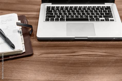 Office Desktop On The Desk Is A Laptop A Notebook With Notes And A Ballpoint Pen Stock Photo