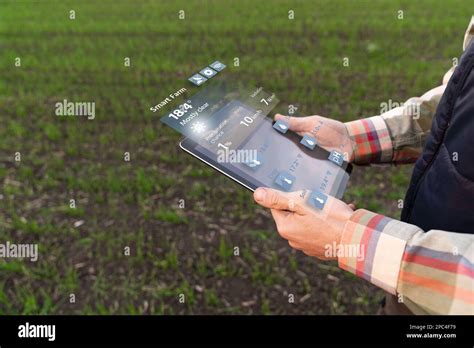 Farmer With Digital Tablet On An Agricultural Field Smart Farming And