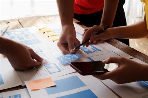 Premium Photo Group Of Ux Developer And Ui Designer Brainstorming About App Interface Design