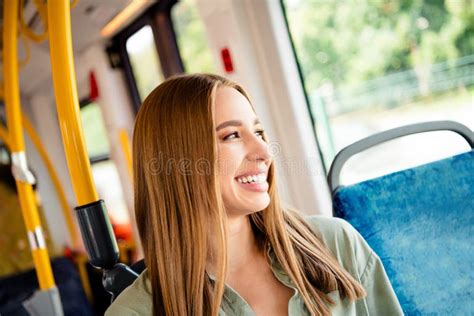 Young Woman Enjoying A Joyful Bus Ride Through The City In Daylight