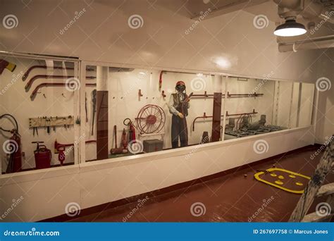 Inside Of The Uss Alabama Battleship With Glass Case Filled With Fire Extinguishers Axes And A