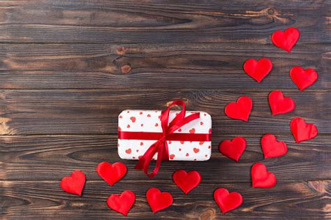 발렌타인 데이 또는 다른 휴일 수 제 종이에으로 현재 휴가 래퍼에 빨간 하트와 선물 상자 디자인에 대 한 어두운 나무 테이블 상단 보기 복사 공간 빈 공간에 선물 상자를