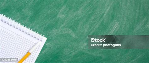 녹색 칠판에 플랫 누워 빈 사각형 노트북과 노란색 펜 복사 공간이 있는 상단 뷰입니다 학교 배너 템플릿 교육 개념으로 돌아갑니다