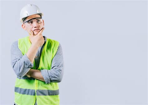 Premium Photo Pensive Male Engineer With Hand On Chin Isolated