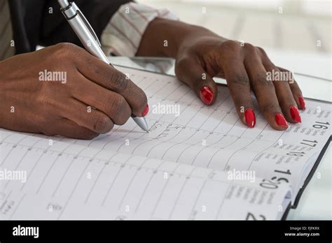 Woman Writing Schedule In Calendar Diary Stock Photo Alamy
