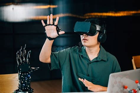 In A Classroom Asian Teenager Wearing Vr Glasses And Controlling A