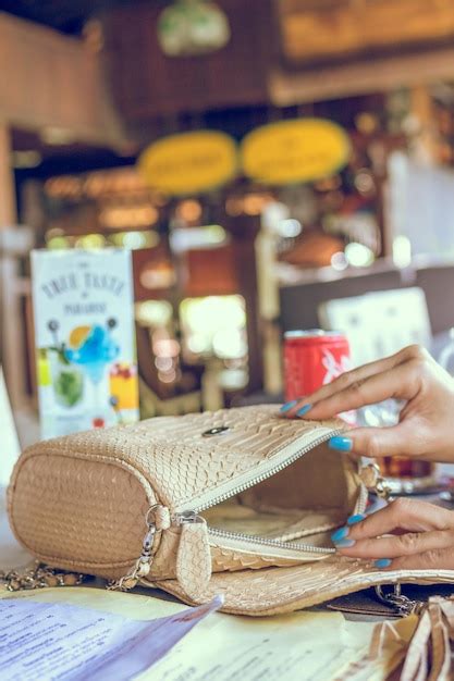 Premium Photo Handmade Bag Made Of Exotic Python Skin In The Hands Of