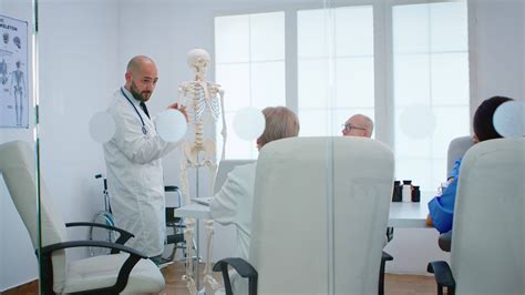 Professional Physician Learning Colleagues Body Bone Functionson Using Radiography And Human