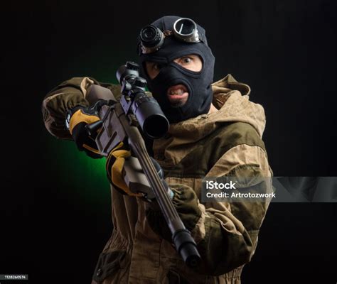 The Guy In Protective Clothing And A Black Mask With A Sniper Rifle