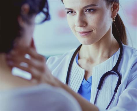 Premium Photo A Serious Female Doctor Examining A Patients Lymph Nodes
