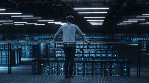 Data Center Engineer Looking Down From A Balcony On Server Farm Cloud