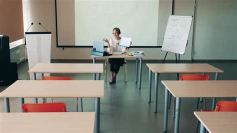 Empty Classroom With A Female Teacher Conducting An Online Class In It Stock Footage