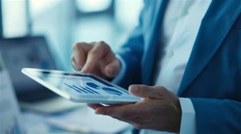 Business Professional Analyzing Financial Data On A Tablet With Focus