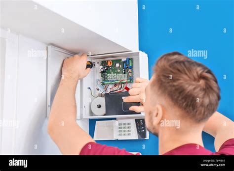 Electrician Installing Alarm System Stock Photo Alamy