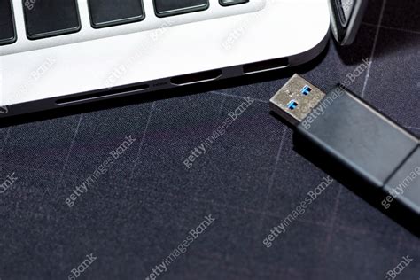 Hand Inserting Usb Flash Memory Drive Plugged Into A Computer Laptop