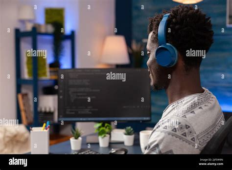 African American Programmer With Headset Programming Website Code On