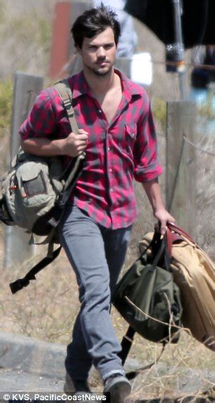 Twilight Hunk Taylor Lautner Shows Off His Muscles As He Strips Down To Just A Pair Of Shorts