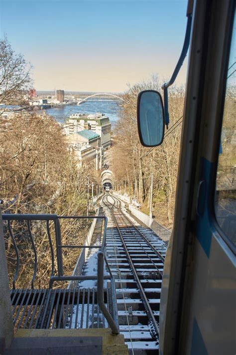 A Blue And White Cable Funicular Rises On Rails Along The Slope