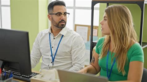 Man And Woman Business Workers Using Computer And Laptop Working At