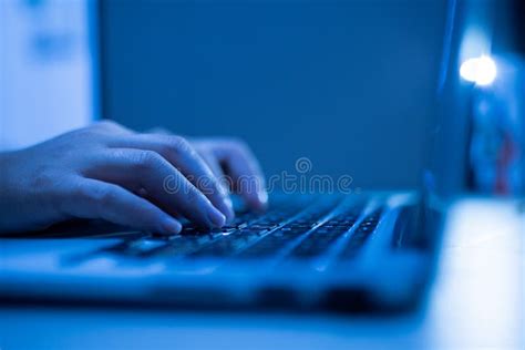 Hand Of A Man Using Laptop Computer For Hacking Or Steal Data At Night In Office Stock Image