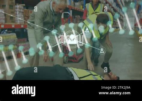 Animation Of Dna Helix Connected Icons Diverse Workers Assisting Unconscious Man In Warehouse