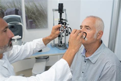 Ophthalmologist Putting Testing Glasses On Patient Stock Image Image