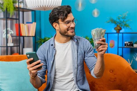 Rich Happy Indian Man Counting Money Cash On Smartphone Calculator App Calculate Income
