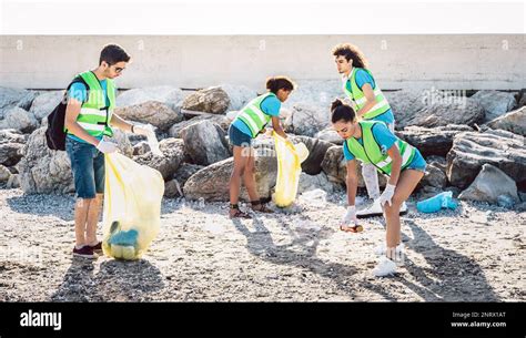 Social Volunteers Wearing Uniform At Beach Shore Cleaning Activity Over