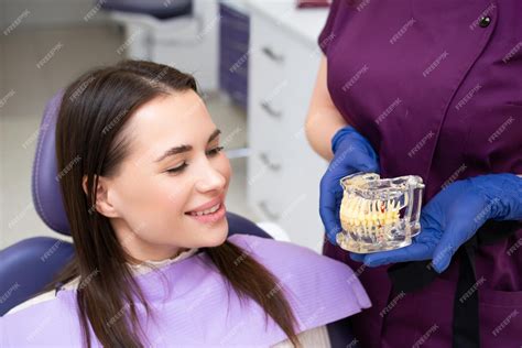 Premium Photo Orthodontist Explains The Procedure Of Alignment Of Teeth To The Patient Using A