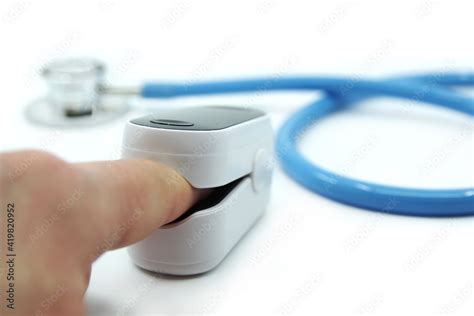 Pulse Oximeter And Stethoscope Isolated On White Background Pulse Oximeter Used To Measure