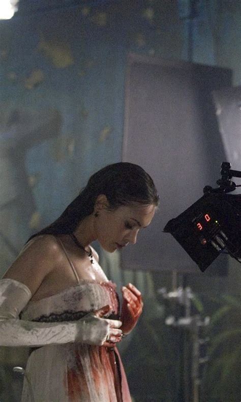 A Woman Standing In Front Of A Camera