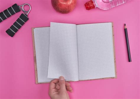Premium Photo Cropped Hand Turning Page Of Book Against Pink Background