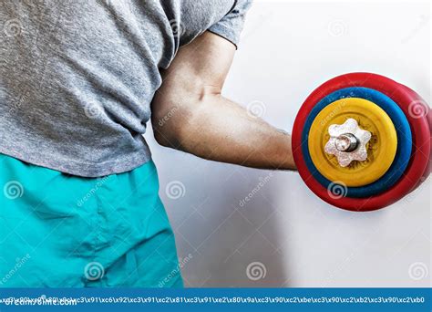 Male Athlete Lifting A Heavy Dumbbell With One Hand Home Workouts