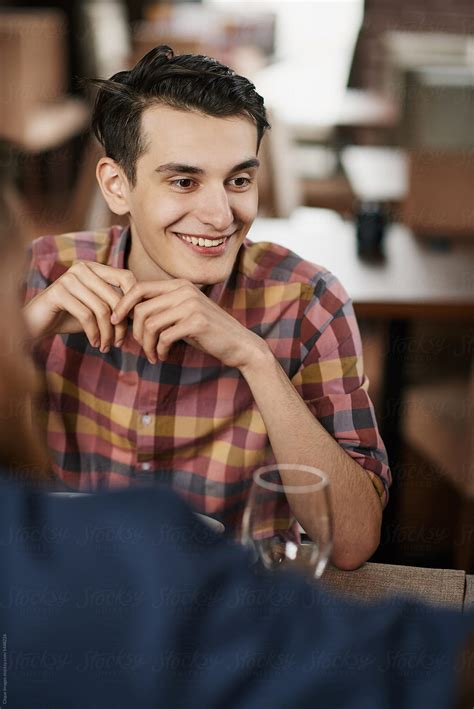 Young Man Dining With Friends By Stocksy Contributor Clique Images Stocksy