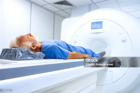 Hospital Diagnostic Room With Patient Laying Down In Mri Scanner Stock