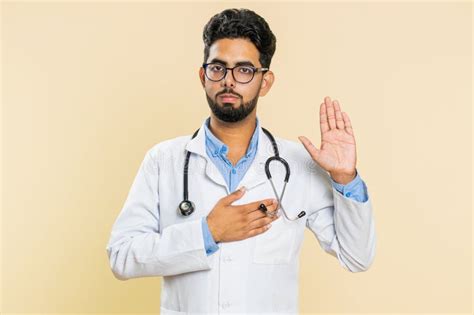 Doctor Man Raising Hand To Take Oath Promising To Be Honest And To Tell Truth Keeping Hand On