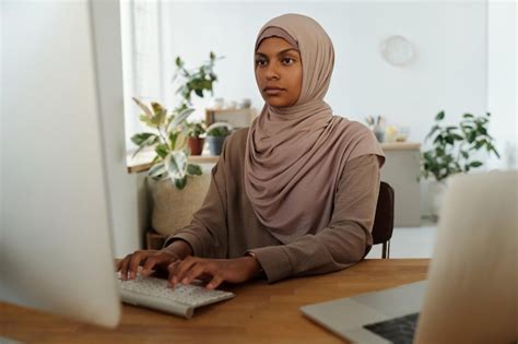 Premium Photo Young Serious Female Programmer Looking At Computer