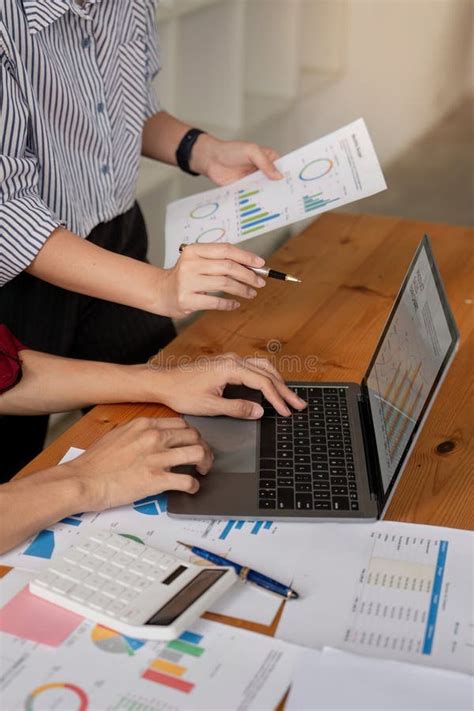 Business Team Collaboration On Data Analysis With Charts And Graph In