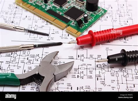 Printed Circuit Board With Electrical Components Precision Tools And Cable Of Multimeter On