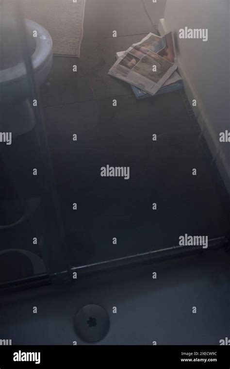 Looking Through A Misty Shower Door To The Bathroom Outside Of The