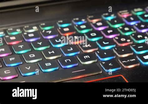 Handheld Camera View Of Dirty Multi Coloured Gaming Pc Keyboard Keys Backlit By Blinking Lights