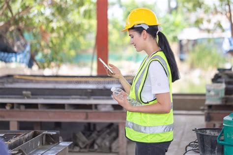 Senior Engineer And Female Foreman Team Checking Project At Precast Concrete Factory Site