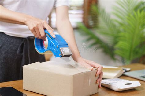 Online Selling Concept Asian Business Women Packing Product Into