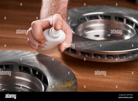 Man Spraying Anti Rust Inhibitor On A Brake Rotor Stock Photo Alamy