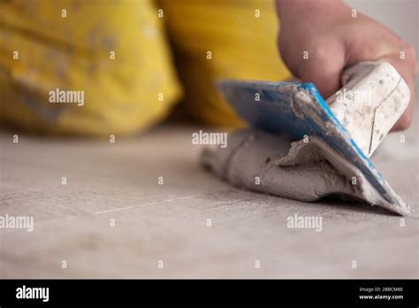 Grouting Ceramic Tiles Tilers Filling The Space Between Ceramic Wood Effect Tiles Using A