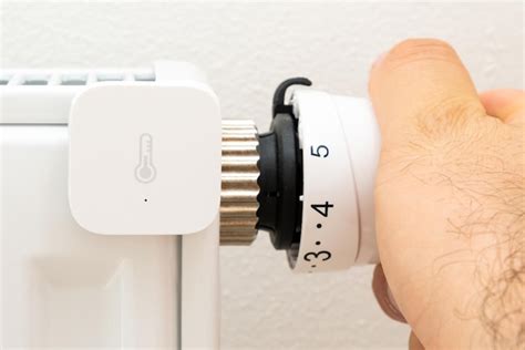 Premium Photo Heat Sensor On The Battery For Temperature Control And Mens Hand Regulated