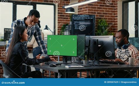 Two Software Developers Analyzing Source Code Looking At Green Screen